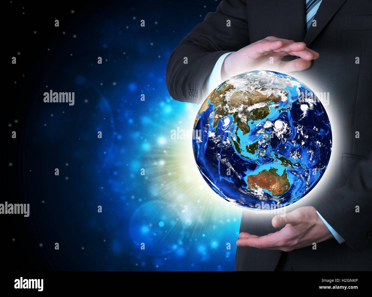 Man in suit holding a earth in hand Stock Photo - Alamy