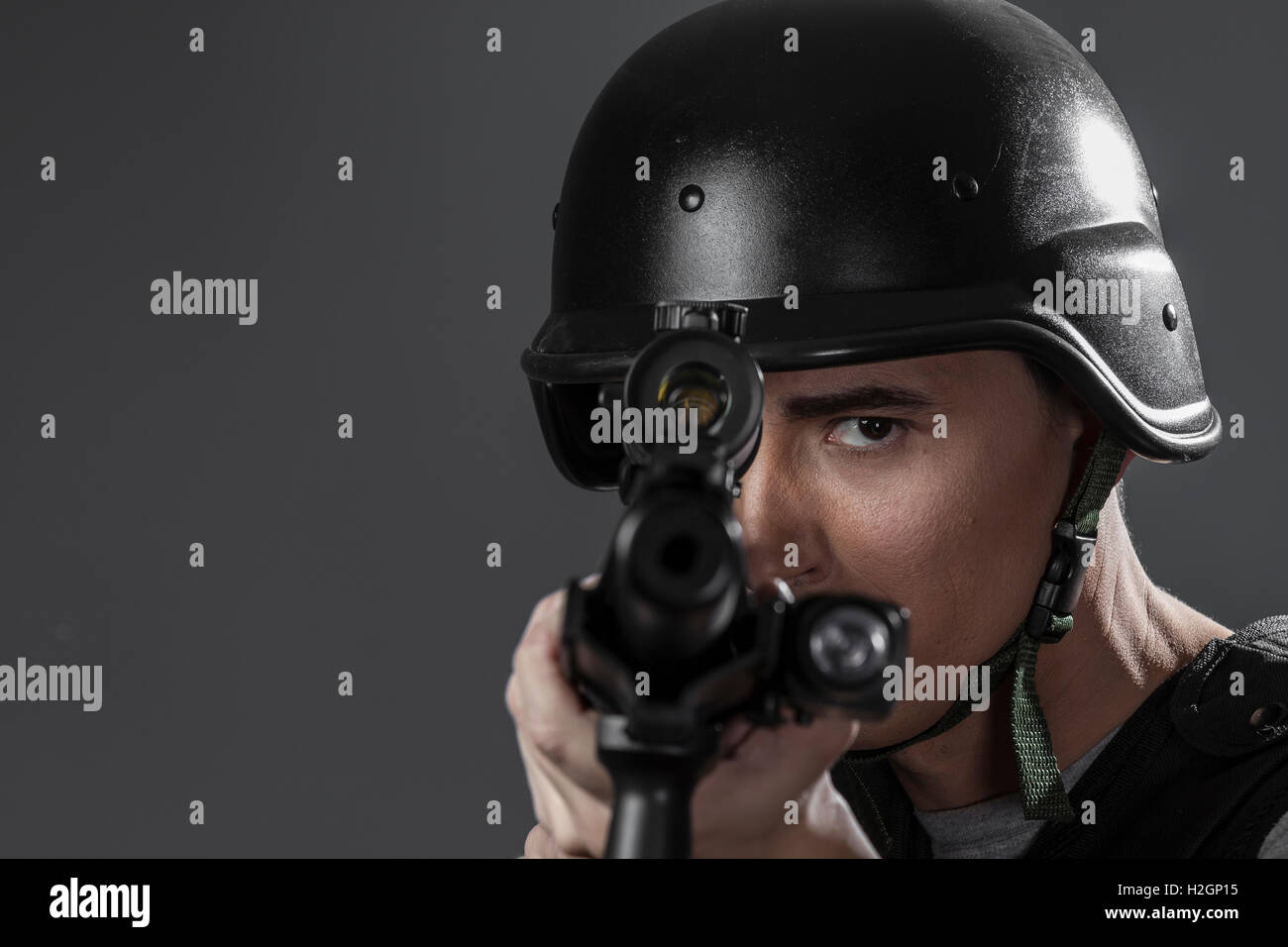 Assault, paintball sport player wearing protective helmet aiming Stock ...