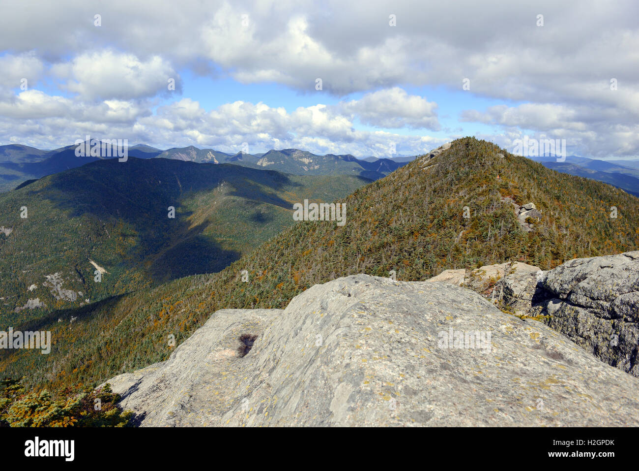 Alpine view from summit of a 46er with vast forests clouds and ...