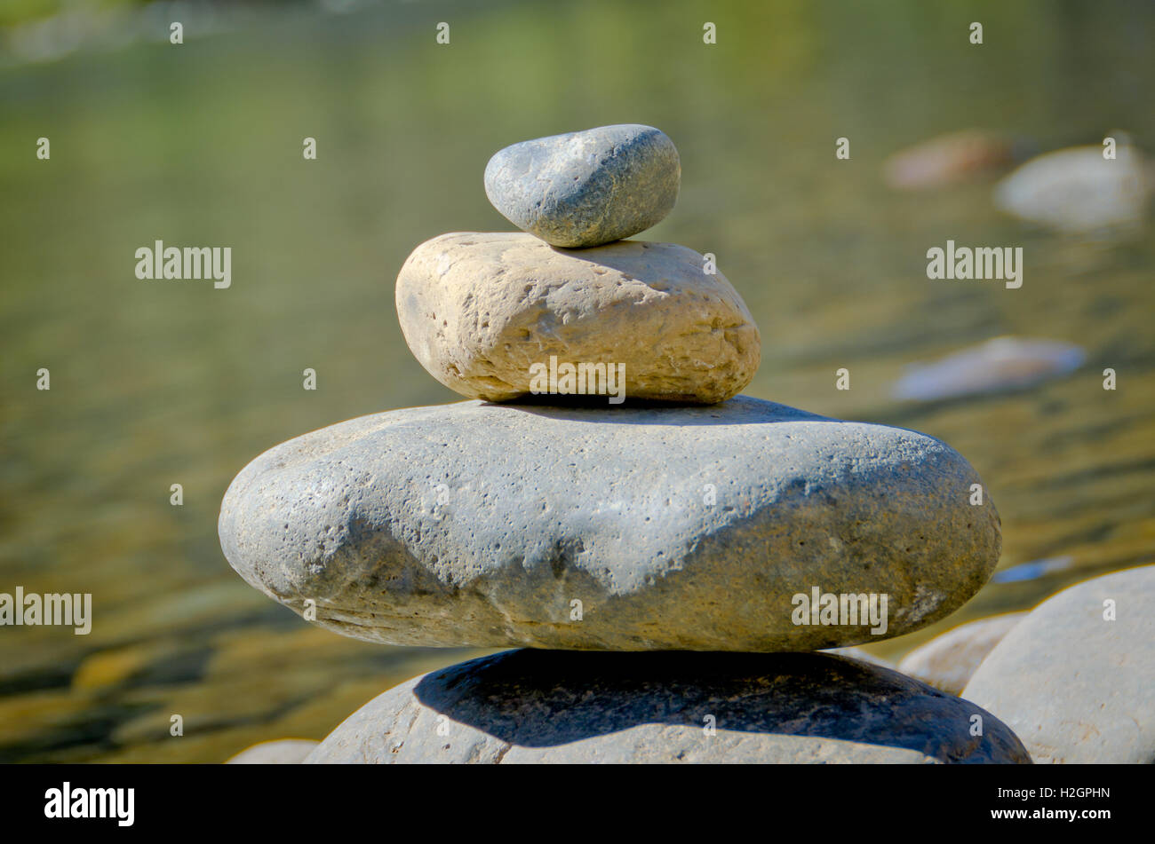 Stack of rocks next to river Stock Photo - Alamy