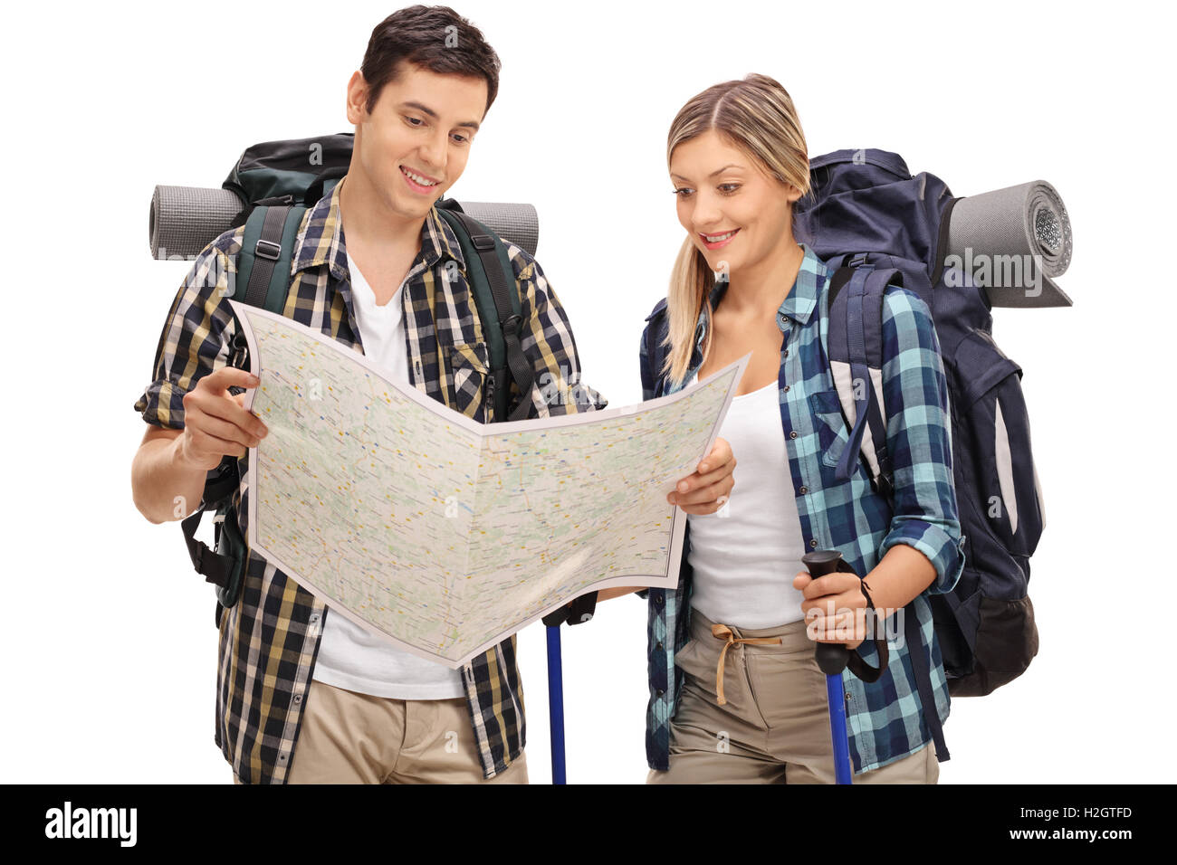 Young hikers looking at a generic map isolated on white background ...