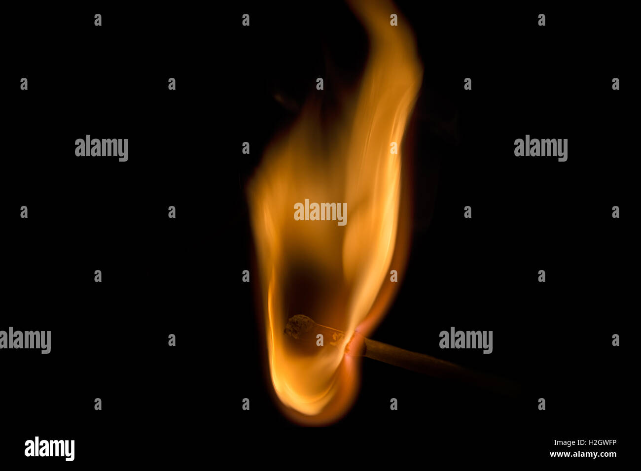 A match being lit isolated against a dark black background Stock Photo ...