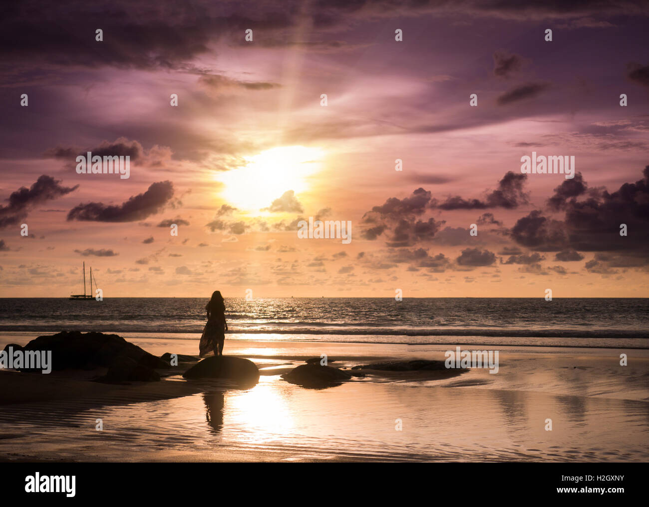 Young woman looking sunset on the beach in Phuket Stock Photo - Alamy