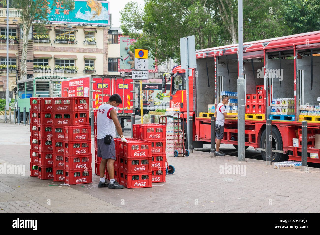 Coca-Cola workers loading bottles on truck in Hong Kong Stock Photo - Alamy