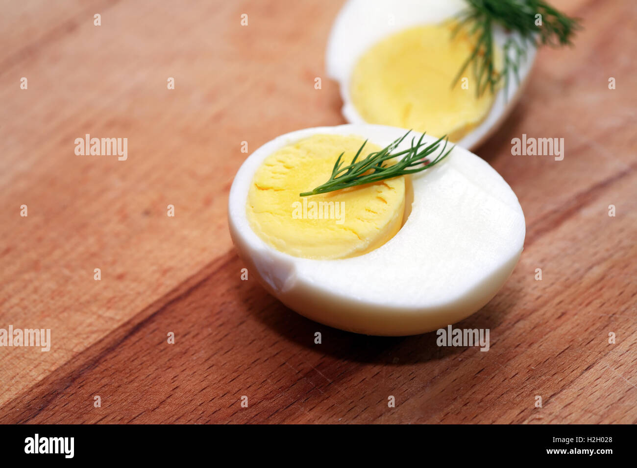 Sliced boiled egg on wooden cutting board Stock Photo - Alamy