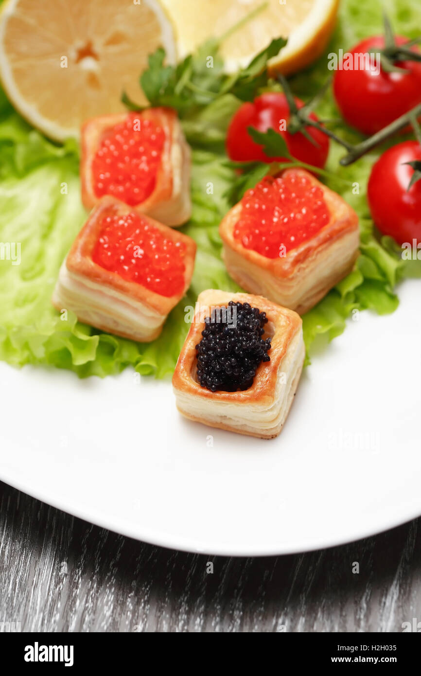 Closeup of tartlet with sturgeon roe on background with red caviar ...