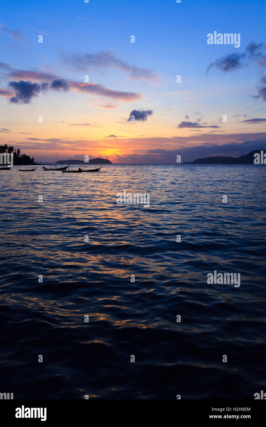 Beautiful sunrise in Rawai Phuket island Thailand with Long tailed boat ...