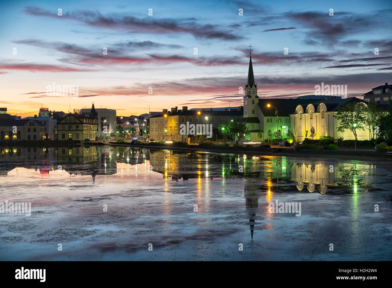 Reykjavik pond shot on a still summer night, Reykjavik city hall and ...