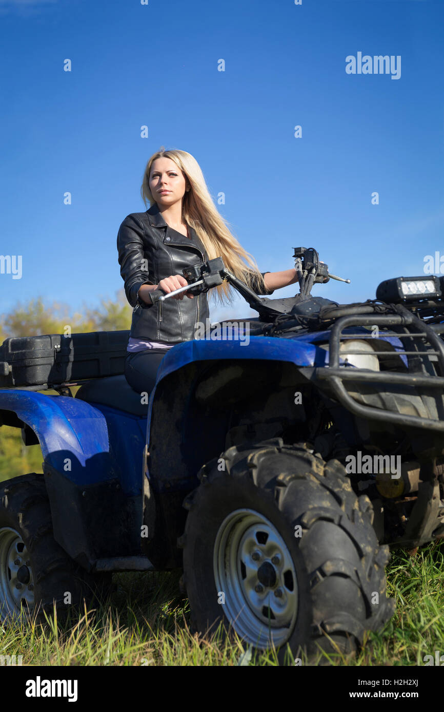 Elegant woman riding extreme quadrocycle ATV Stock Photo - Alamy