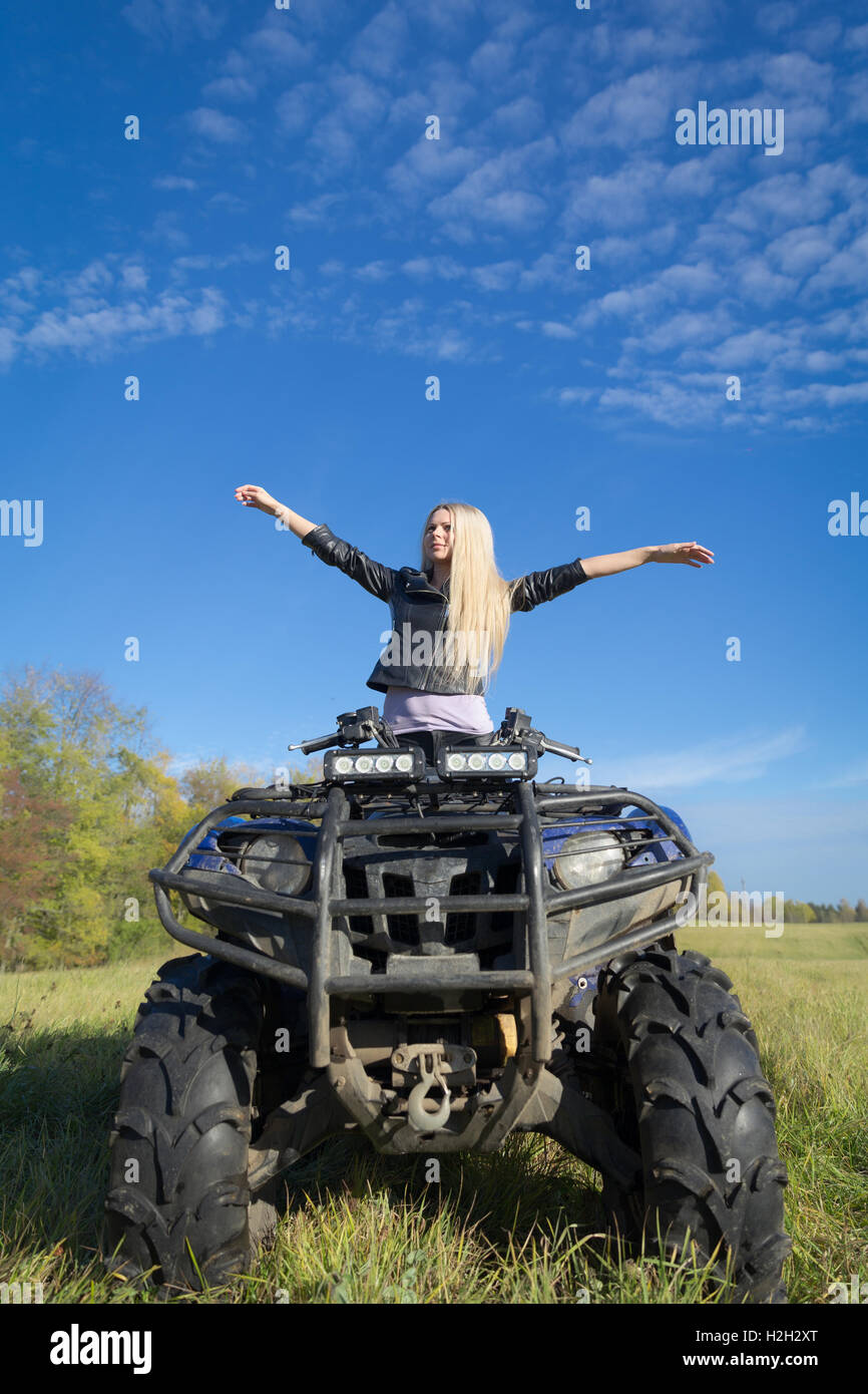 Elegant woman riding extreme quadrocycle ATV Stock Photo - Alamy