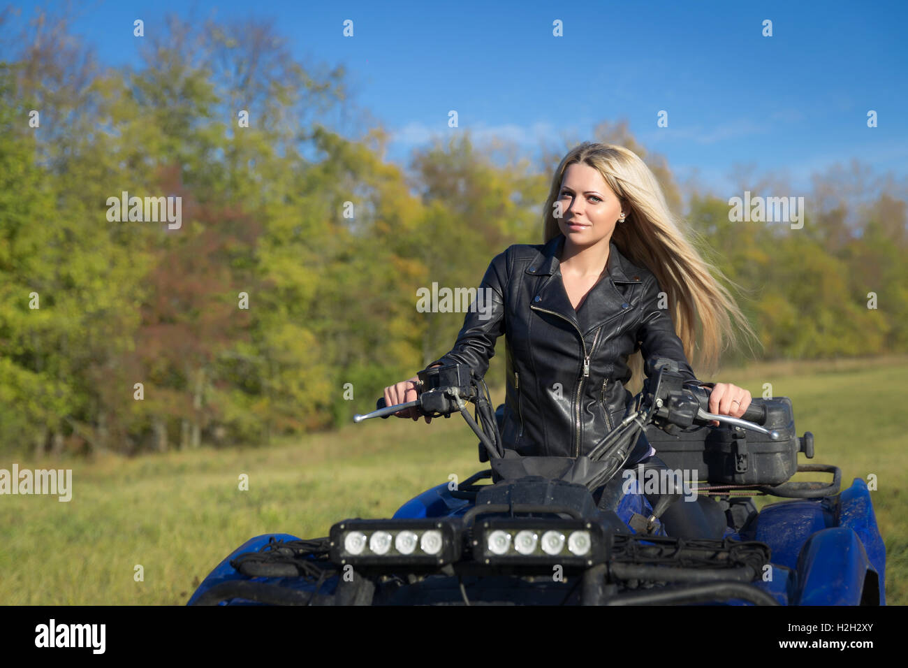 Elegant woman riding extreme quadrocycle ATV Stock Photo - Alamy