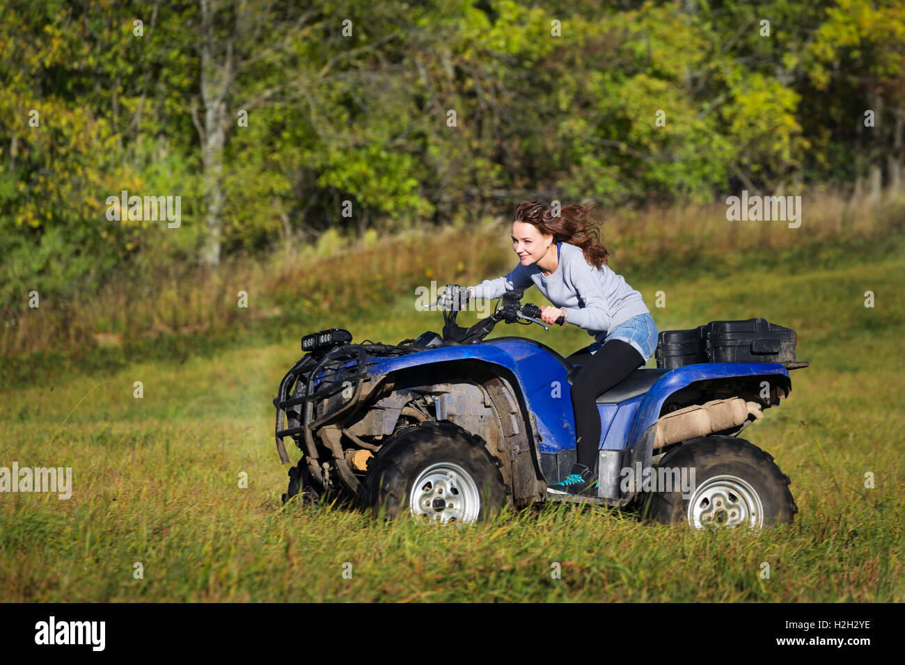 Elegant woman riding extreme quadrocycle ATV on field Stock Photo - Alamy
