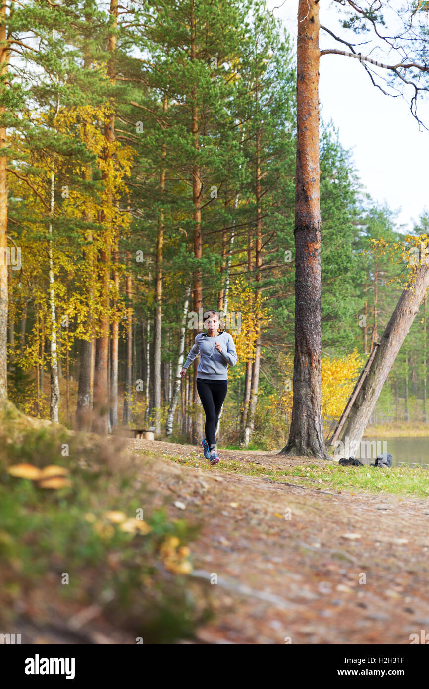 Woman running legs in sunset forest light Stock Photo - Alamy