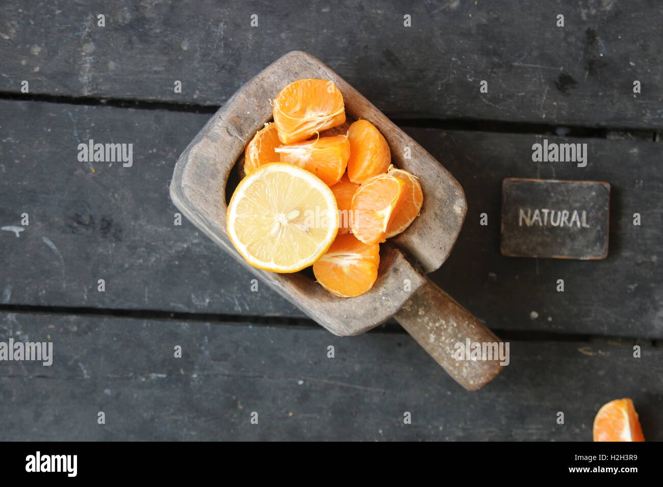 natural sign and slices of mandarin, lemon Stock Photo - Alamy