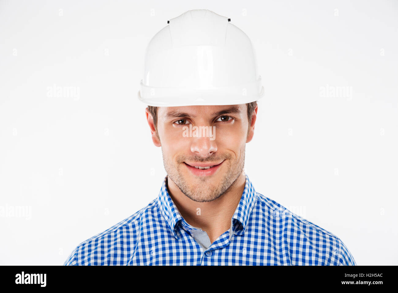 Closeup of smiling young man builder in hard hat Stock Photo - Alamy