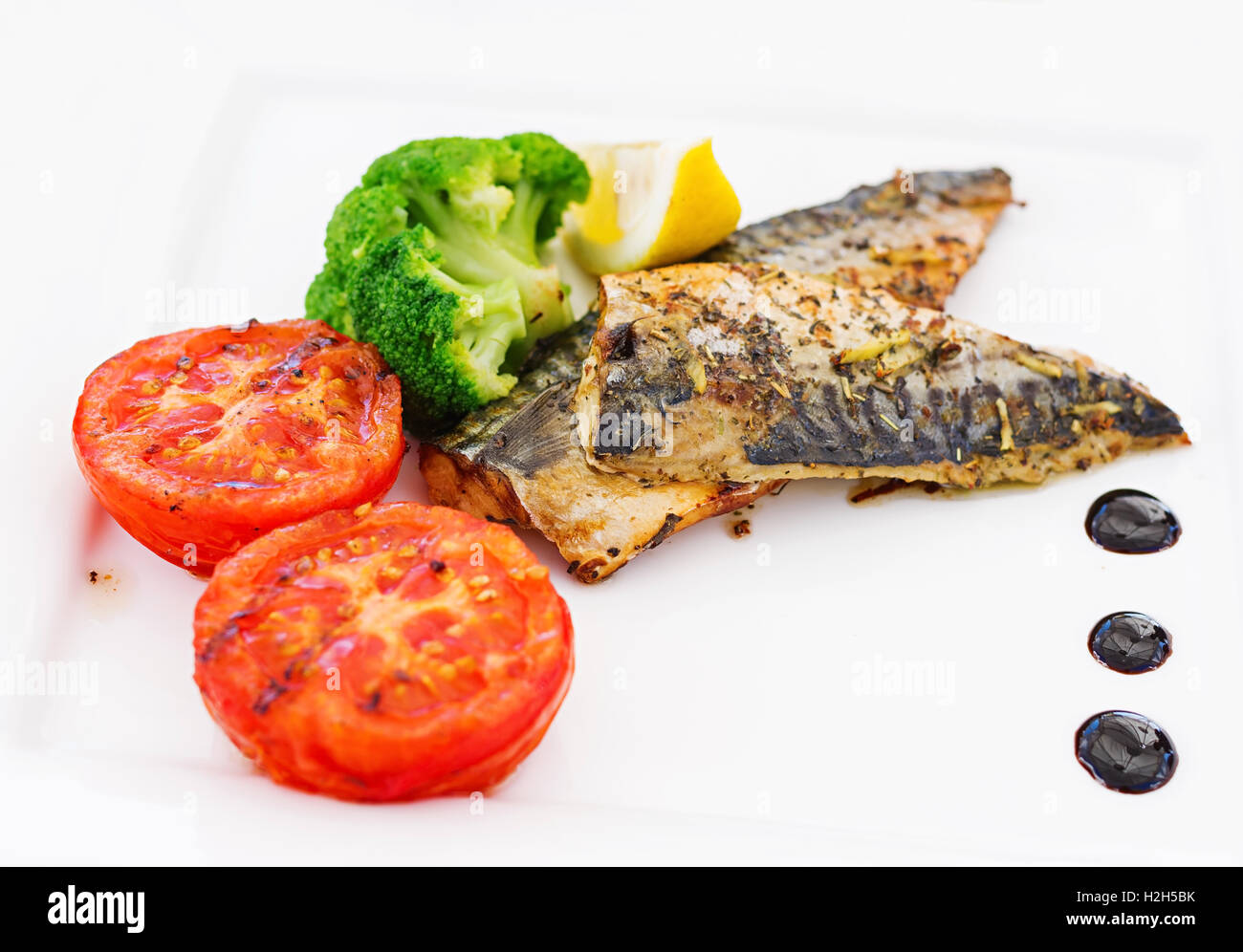 Mackerel fillets (fish) on a grill with vegetables Stock Photo - Alamy