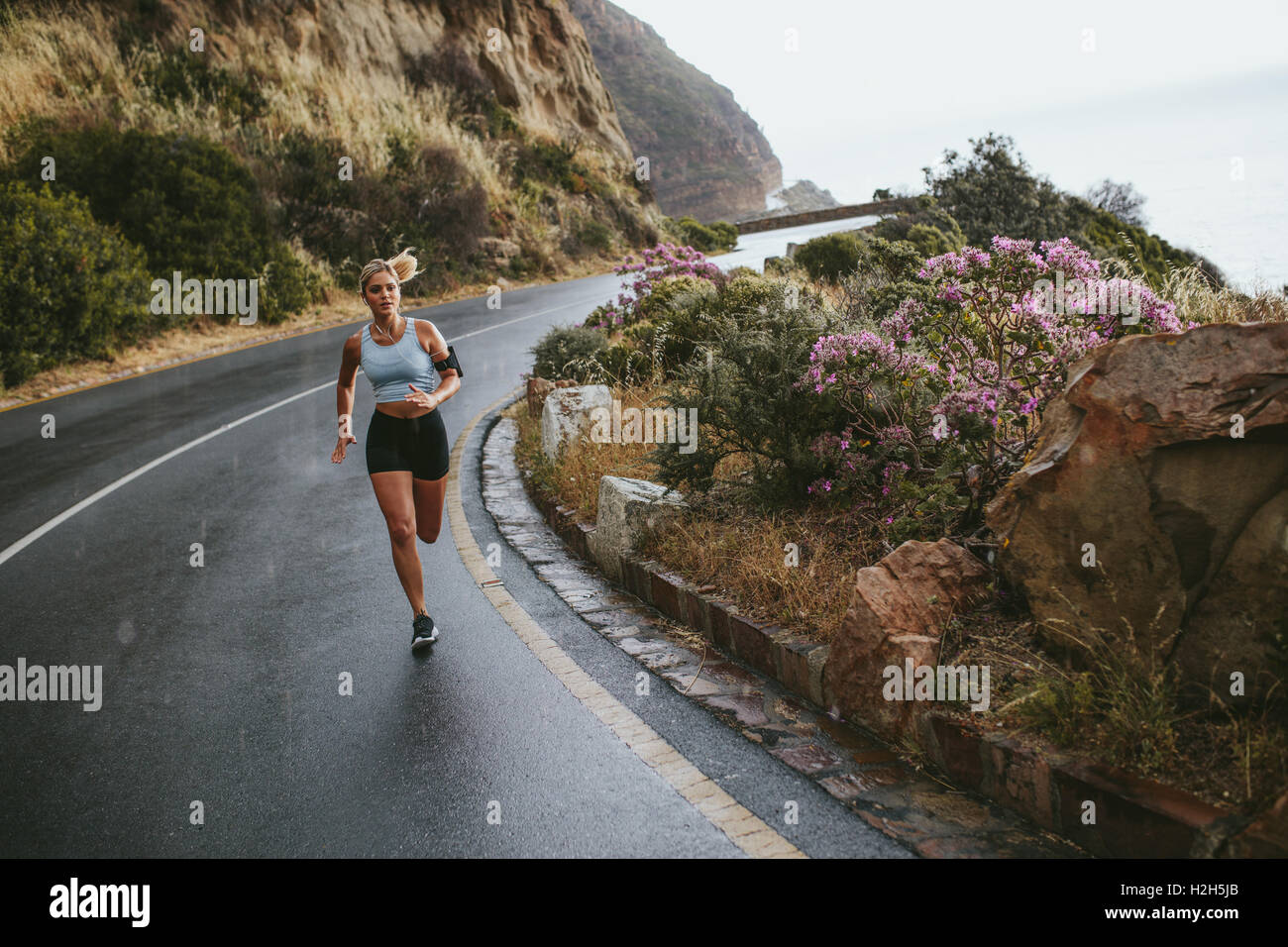 Woman jogging on highway in landscape hi-res stock photography and ...
