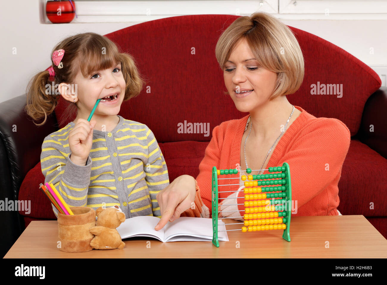 Mom helps daughter to solve homework Stock Photo - Alamy