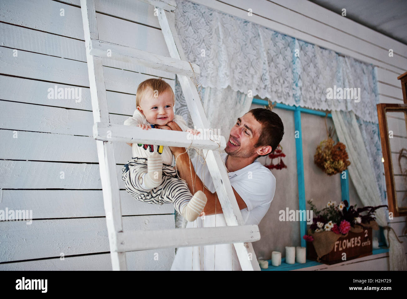 Happy father with son at wooden ladder having fun Stock Photo - Alamy