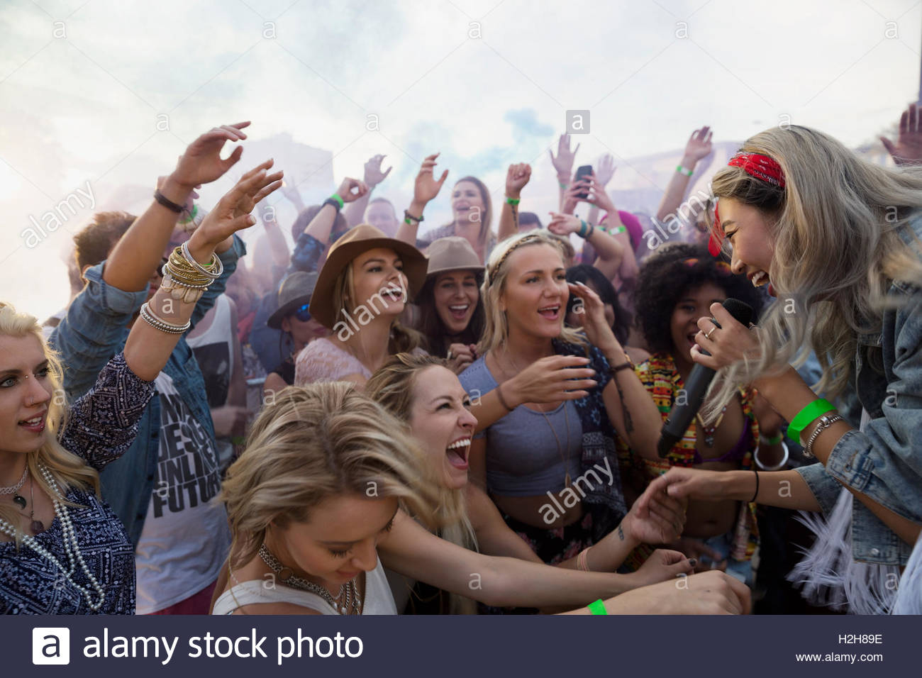 Musician singing and reaching for crowd at summer music festival Stock ...