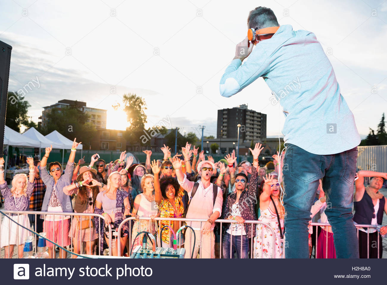Crowd cheering musician on stage at summer music festival Stock Photo ...