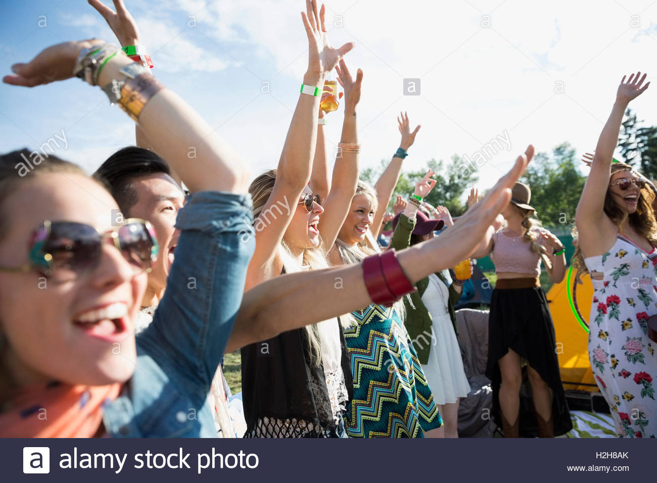 Young crowd cheering at summer music festival Stock Photo - Alamy