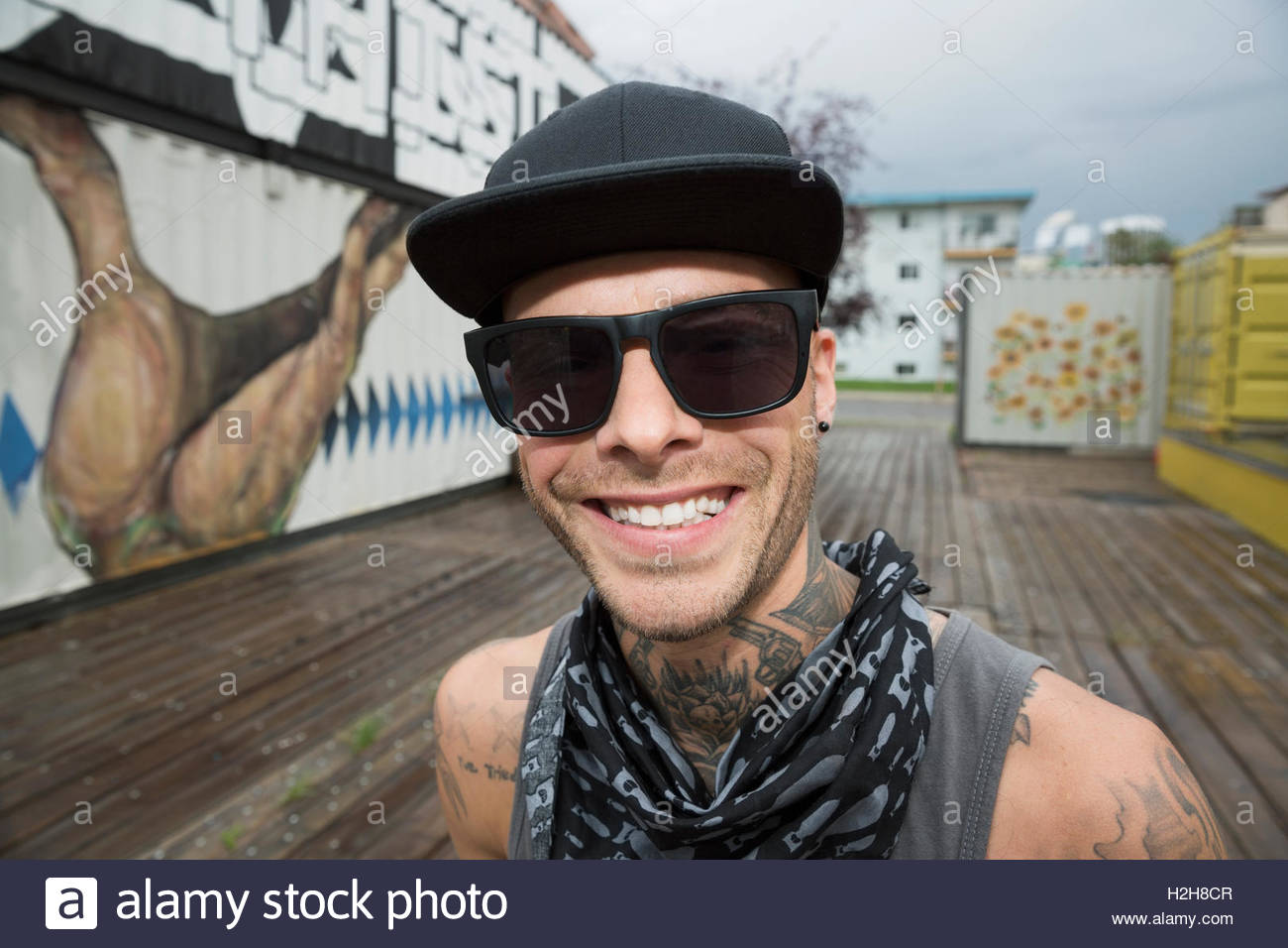 Portrait smiling young man with baseball hat and sunglasses Stock Photo ...