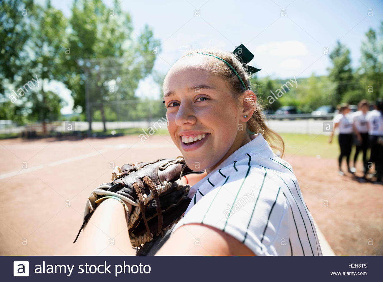 Portrait smiling middle school girl softball player Stock Photo - Alamy