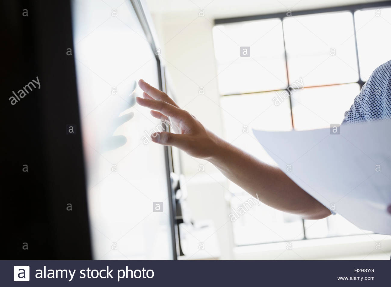Businessman with paperwork using touch screen television Stock Photo ...