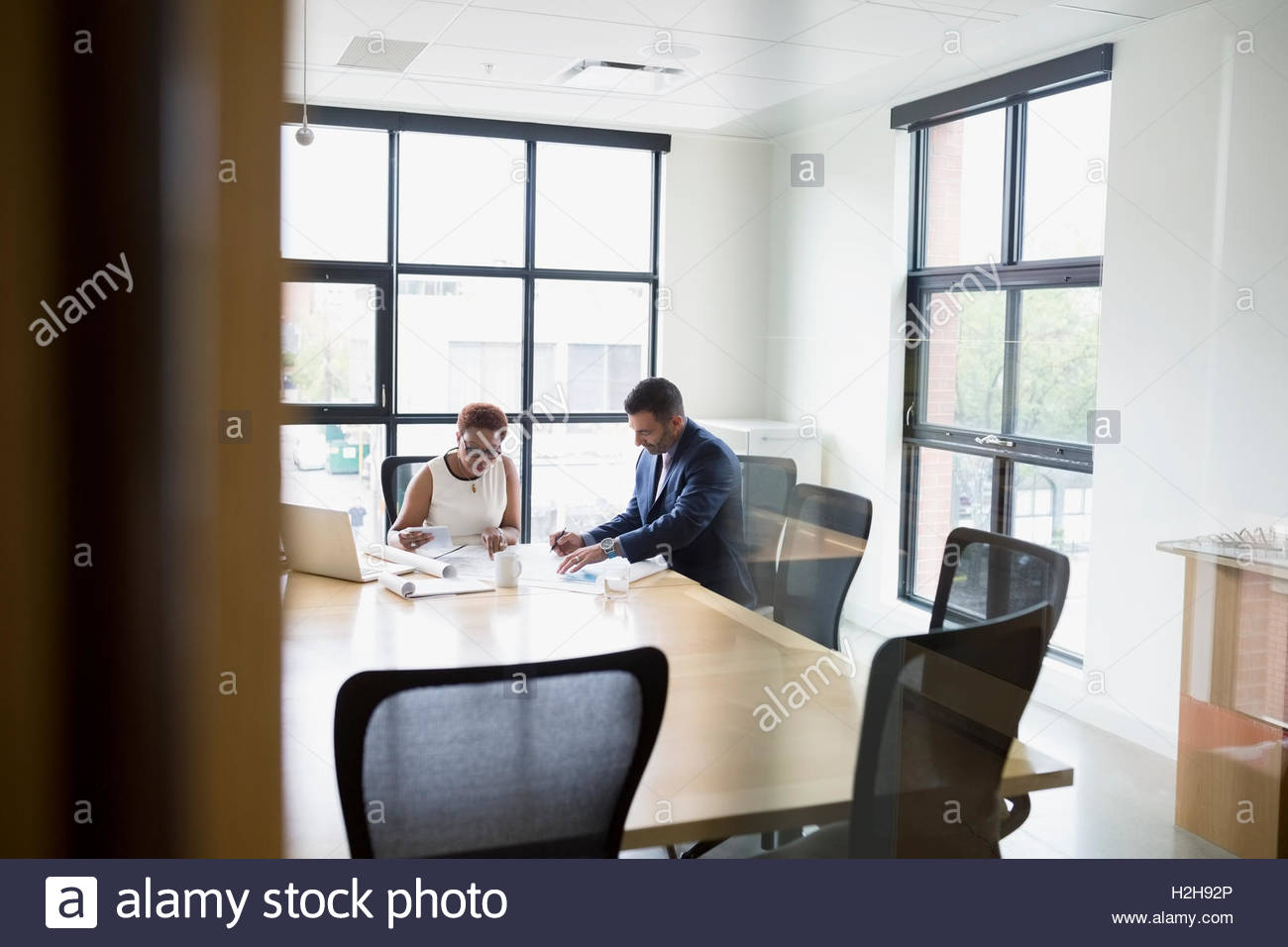 Architects working in conference room Stock Photo - Alamy