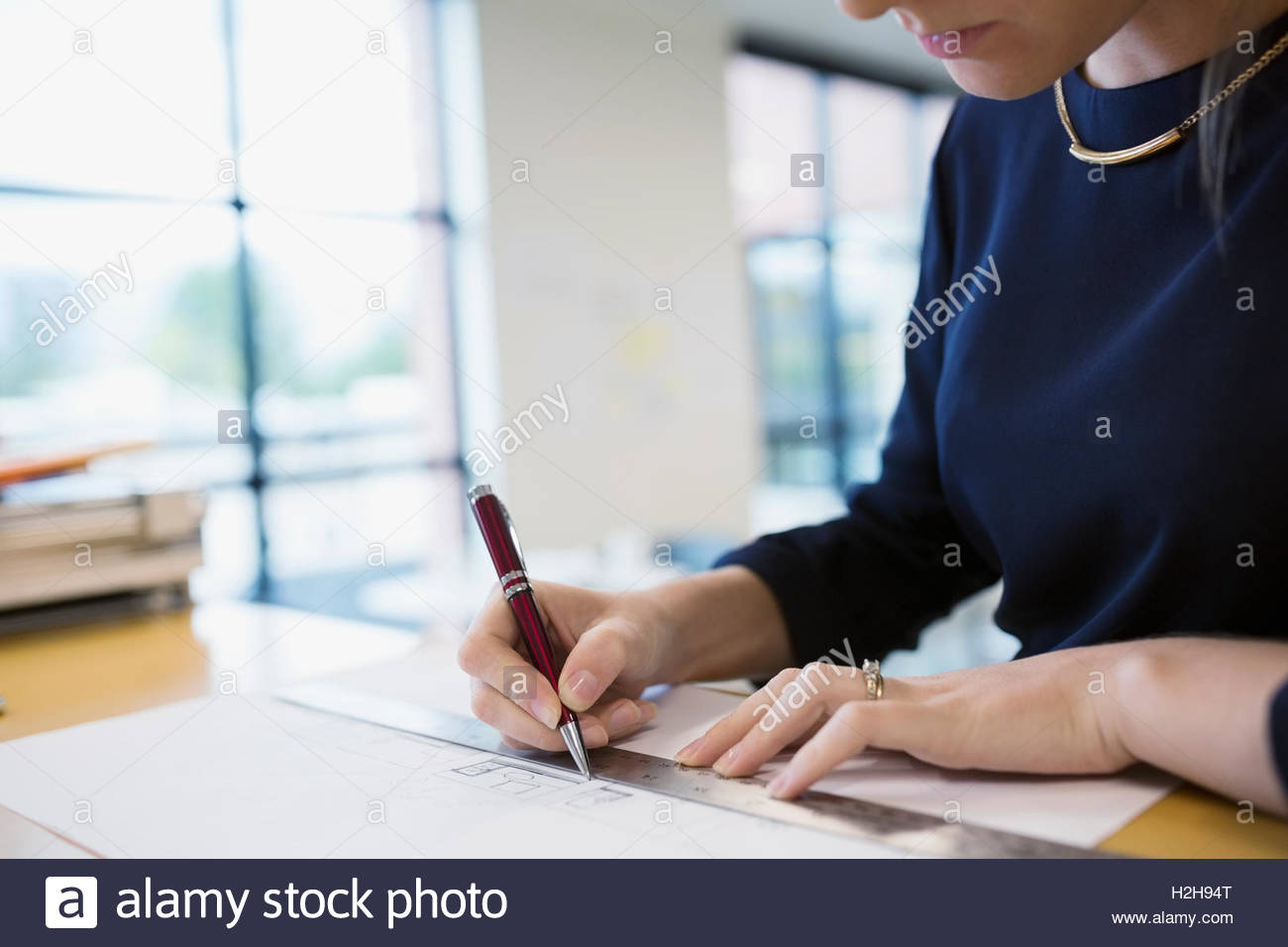 Close up female architect drafting blueprint in office Stock Photo - Alamy