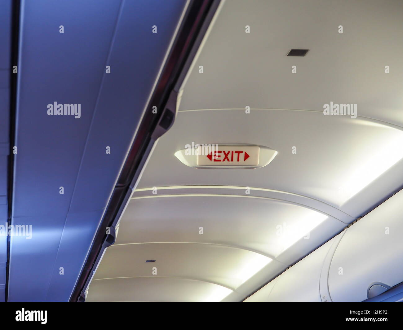Exit Light emergency on plane Stock Photo - Alamy