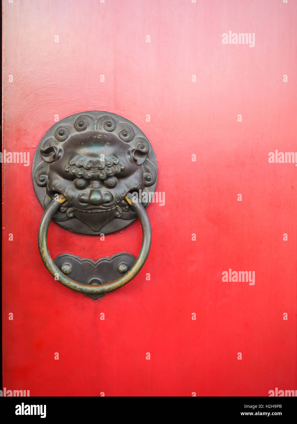 Lion bell with red gates doors Stock Photo - Alamy