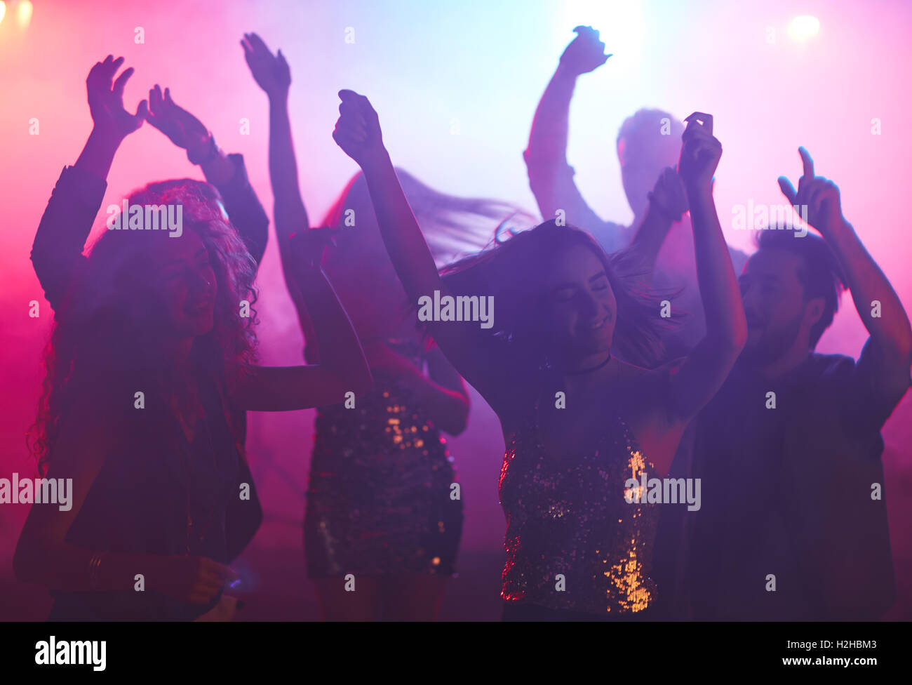 Group of happy girls and guys dancing at night party Stock Photo - Alamy