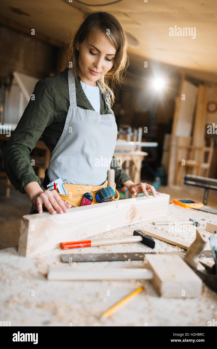 Female carpenter processing wooden plank in workshop Stock Photo - Alamy