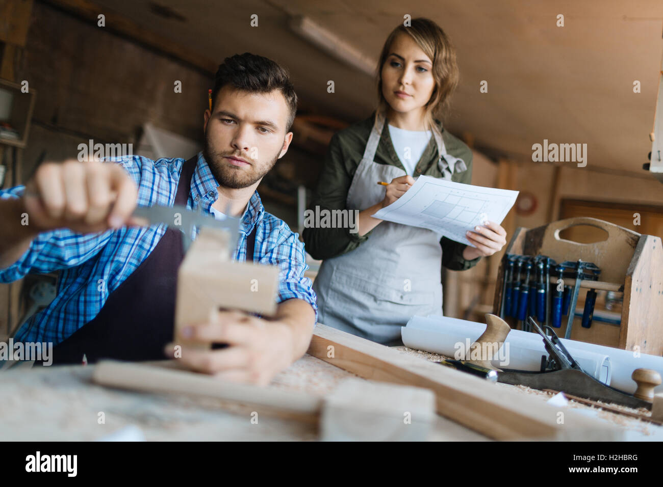 Male carpenter measuring width of wooden plank Stock Photo - Alamy