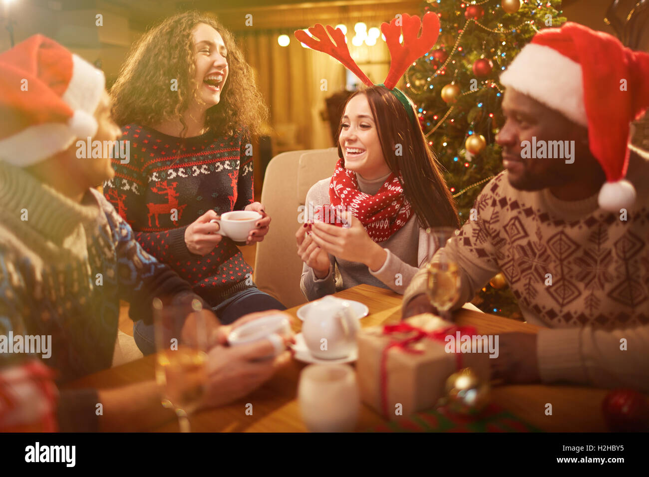 Laughing friends having tea and talking Stock Photo - Alamy
