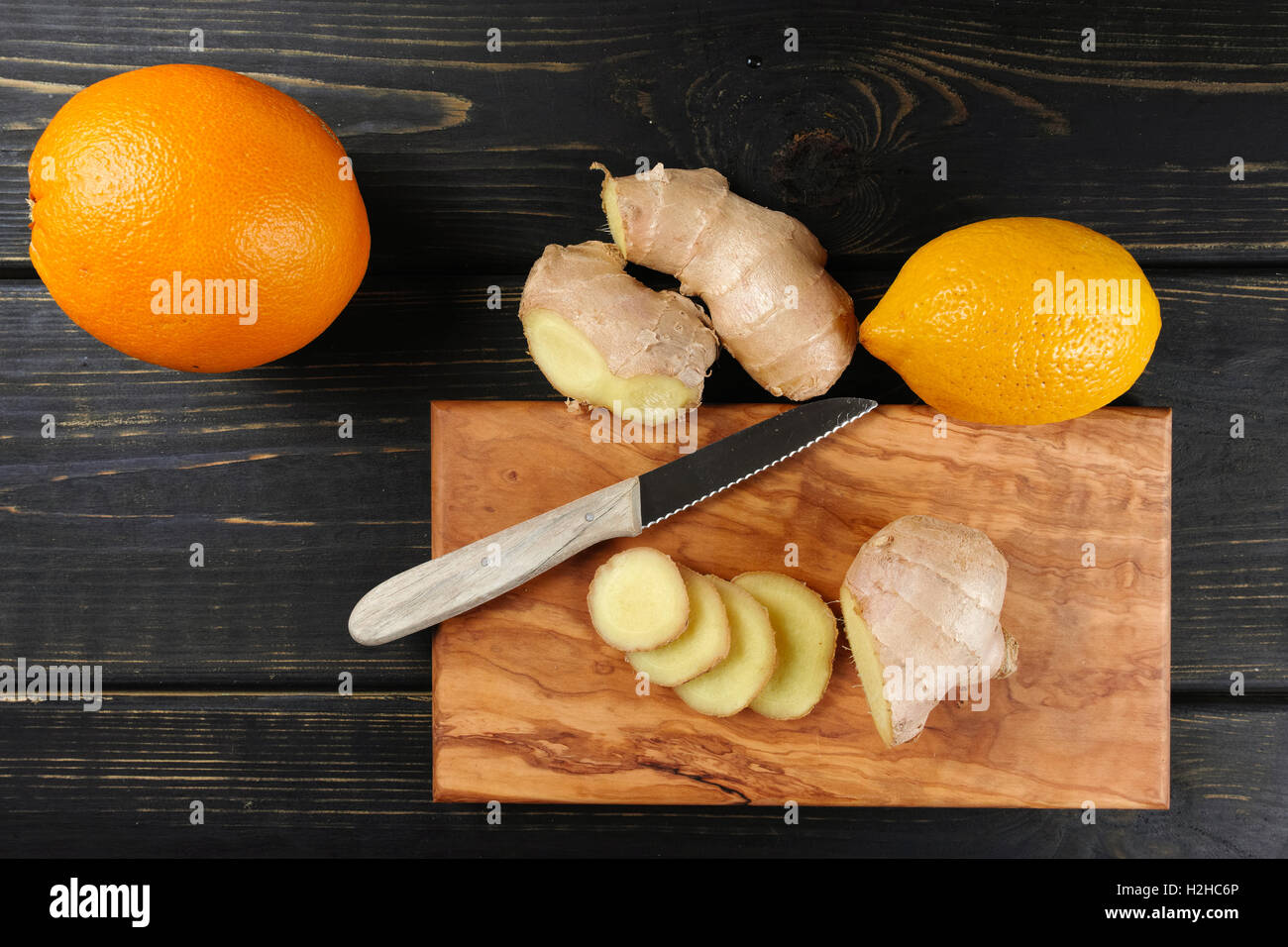 Natural flu and cold remedy - orange and lemon fruit, fresh ginger over ...