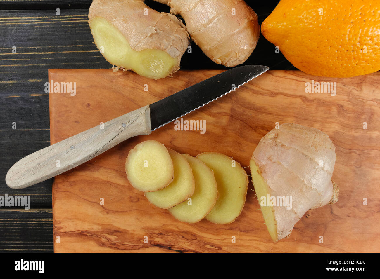 Natural flu and cold remedy - orange and lemon fruit, fresh ginger over ...