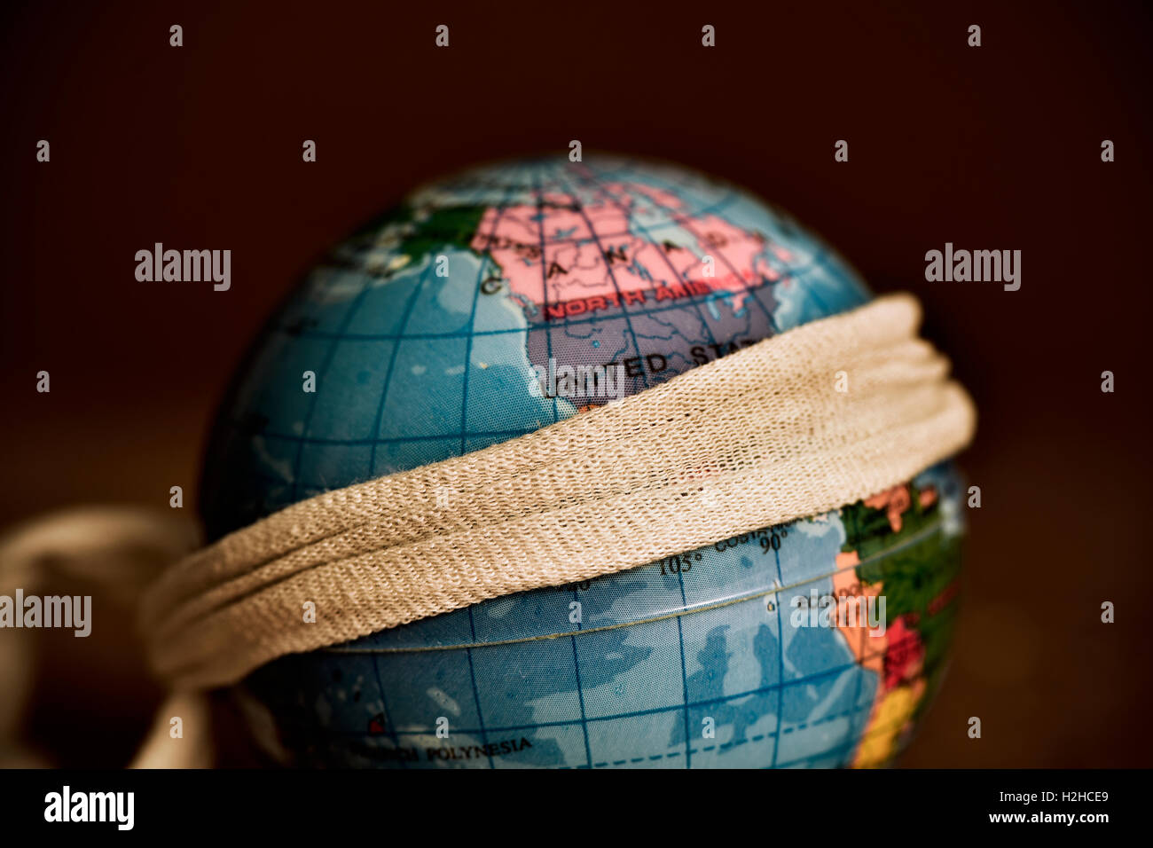 closeup of a terrestrial globe with a piece of cloth tied around it, as ...