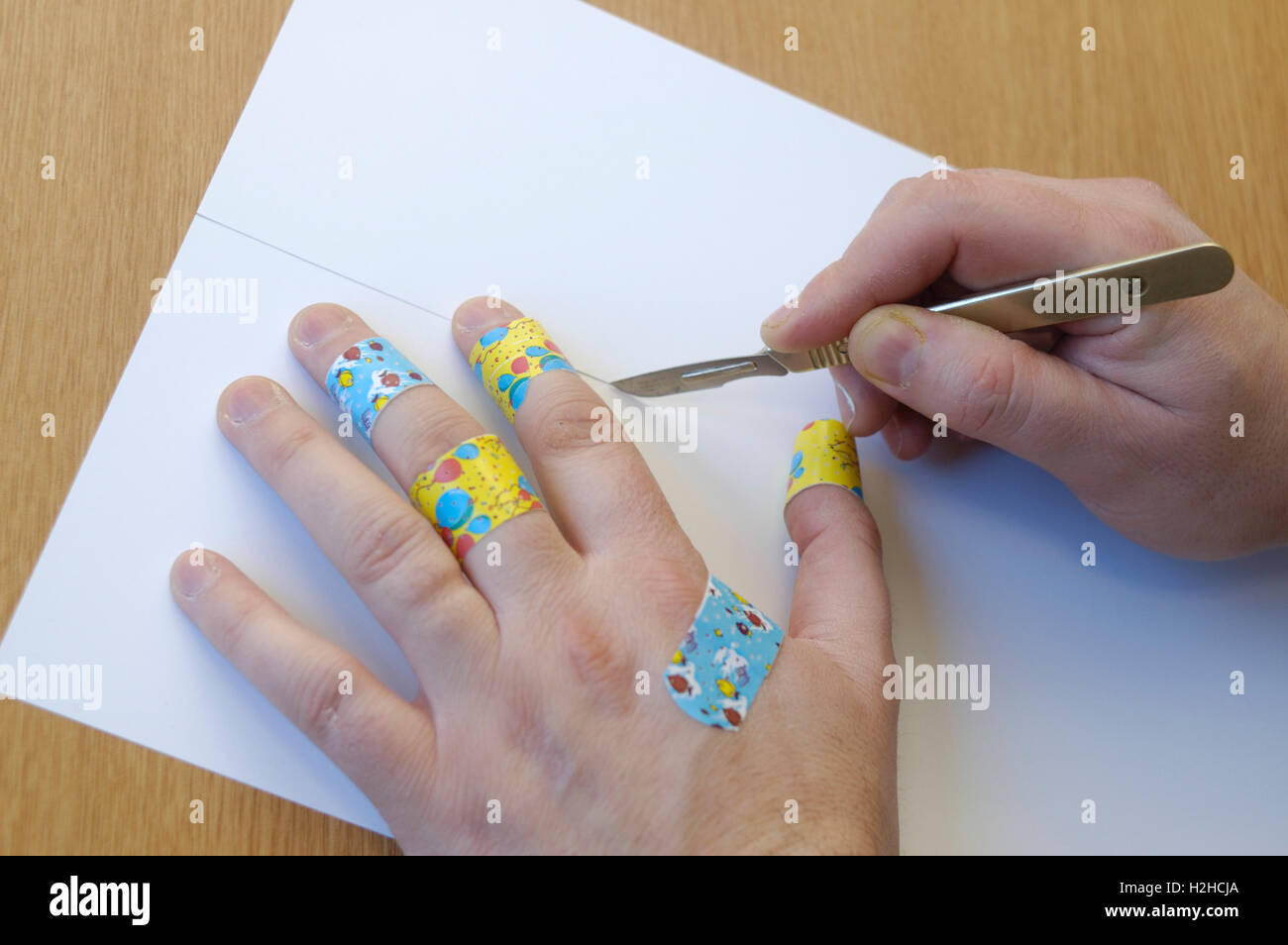 Man using Knife with cut fingers Stock Photo - Alamy