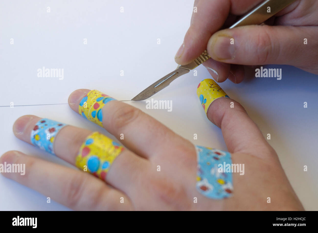 Man using Knife with cut fingers Stock Photo - Alamy