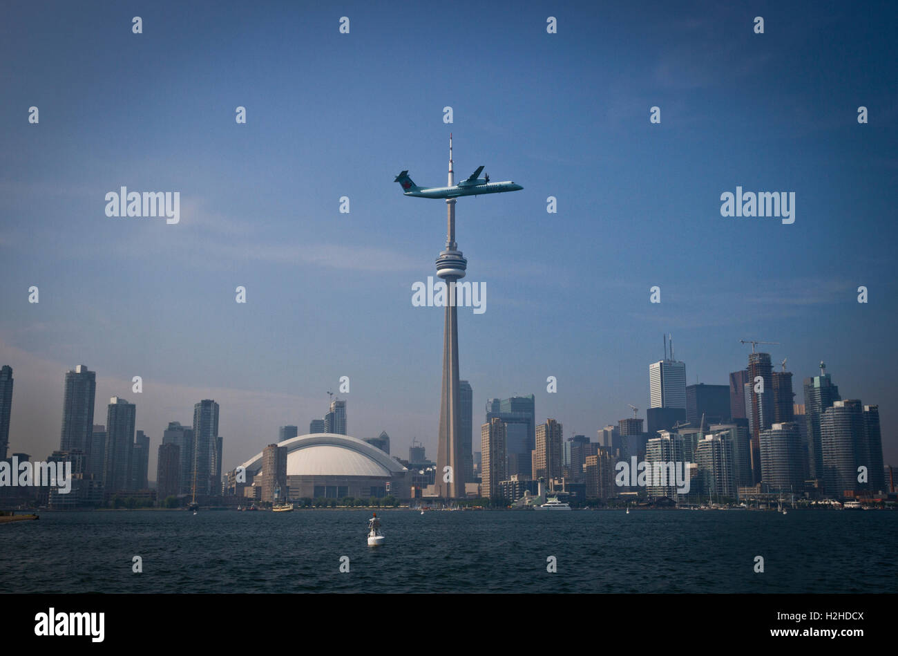 A plane takes off in front of a view of the CN Tower from the islands ...