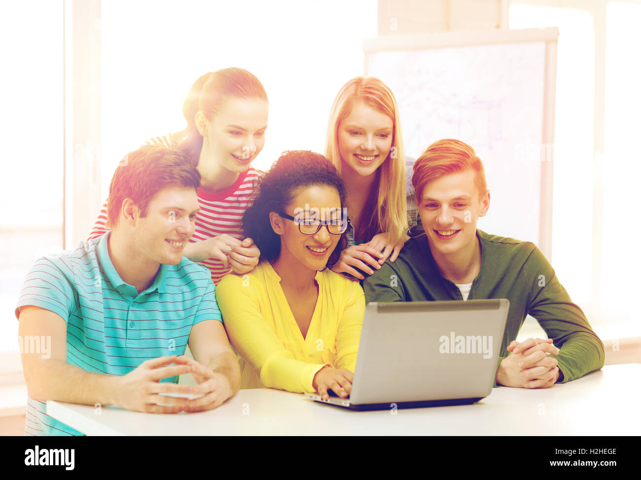 smiling students looking at laptop at school Stock Photo - Alamy