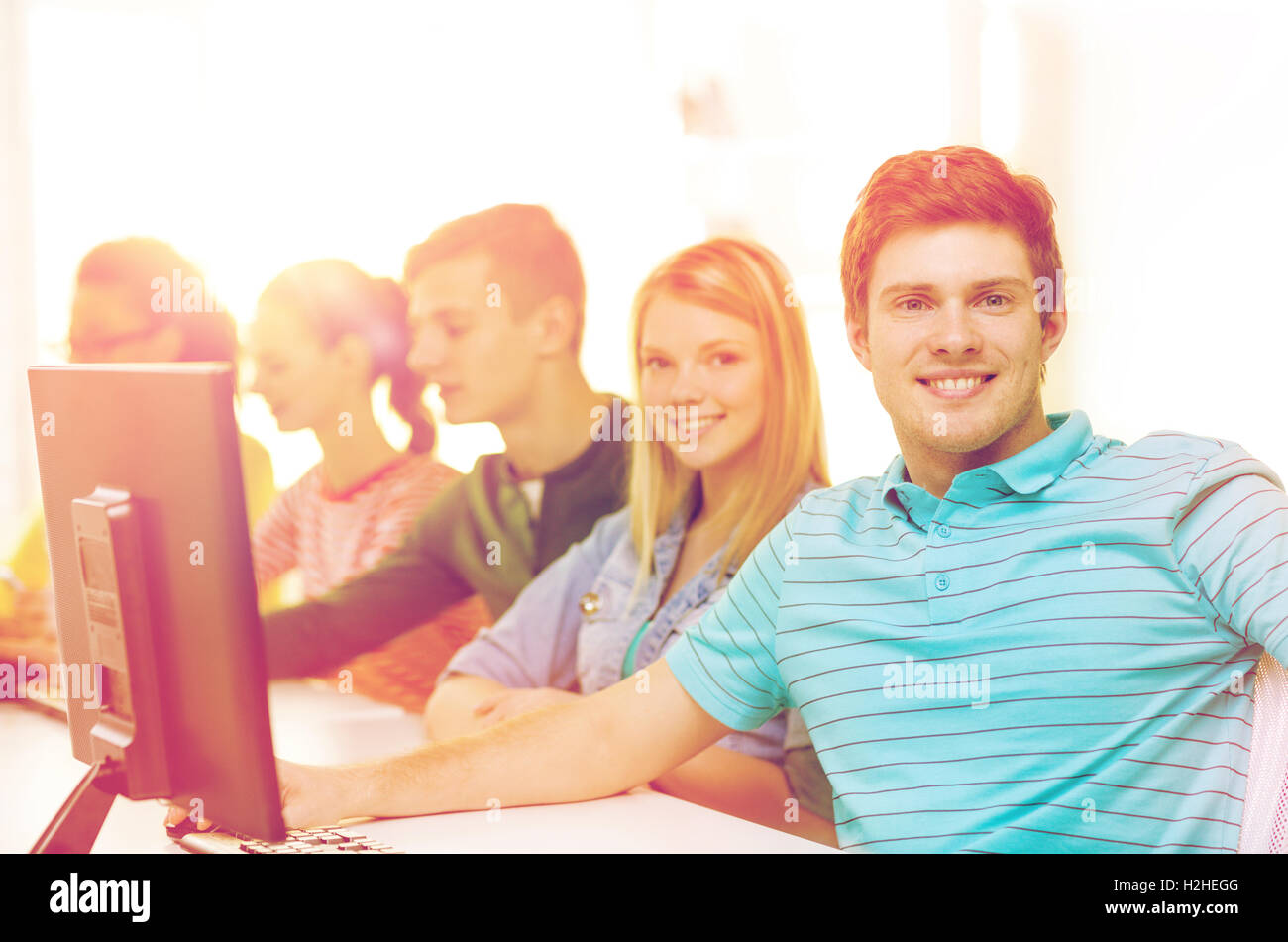 male student with classmates in computer class Stock Photo - Alamy