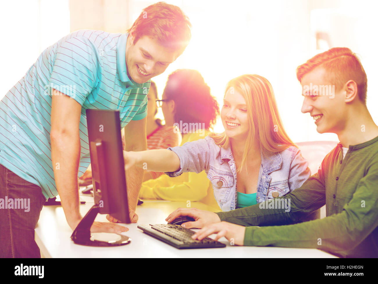 smiling students in computer class at school Stock Photo - Alamy
