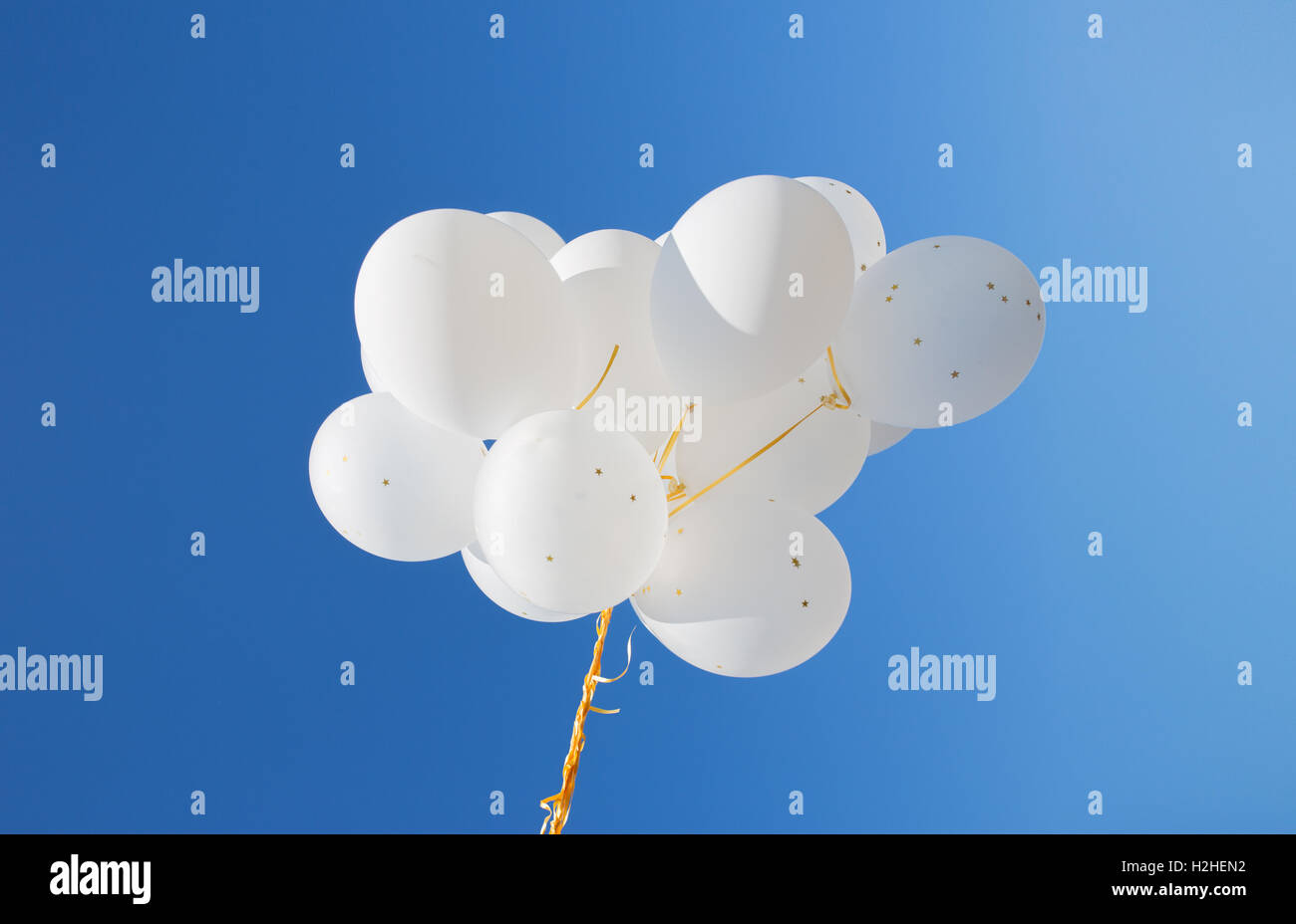 close up of white helium balloons in blue sky Stock Photo - Alamy