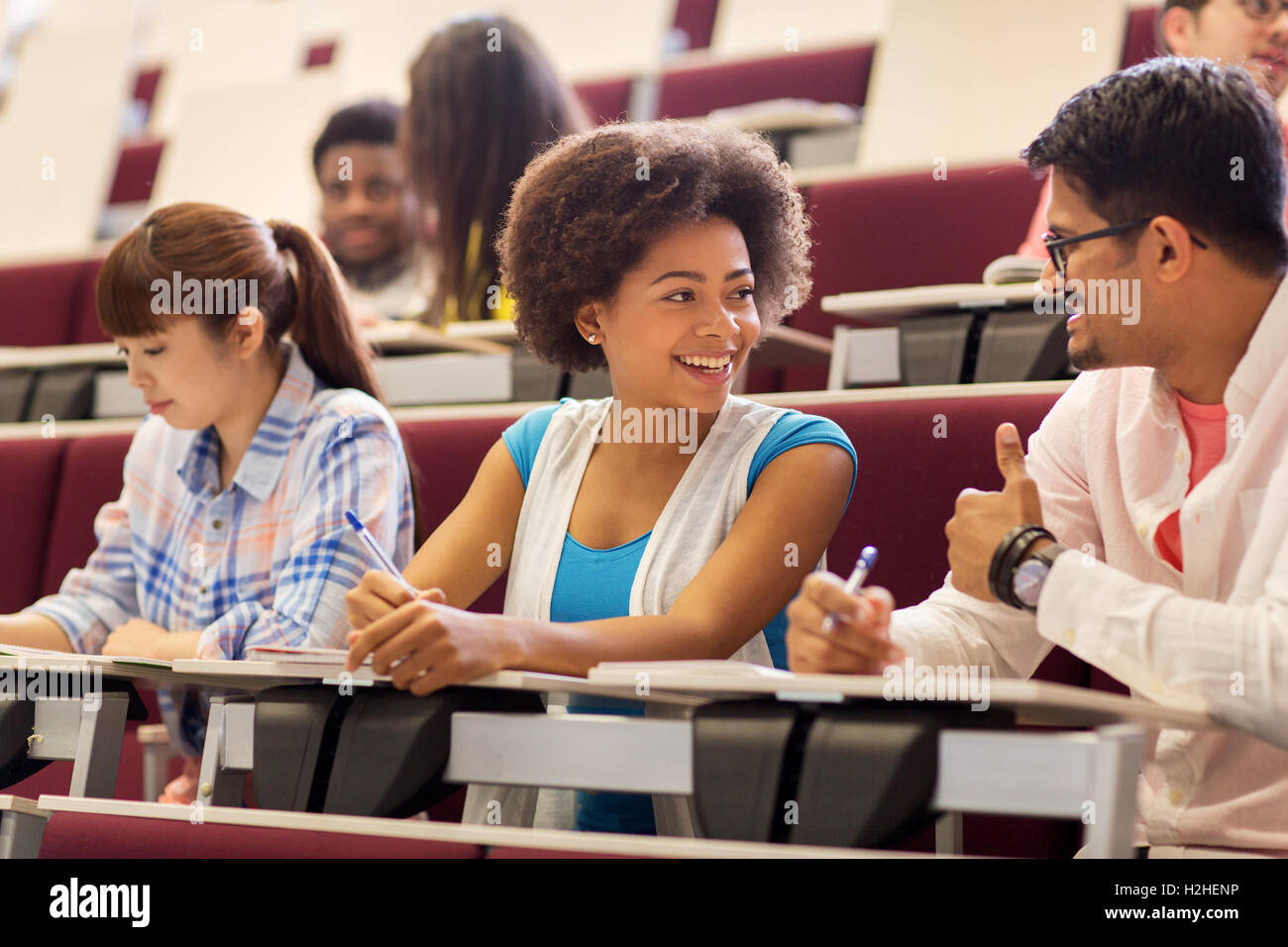 group of students with notebooks in lecture hall Stock Photo - Alamy