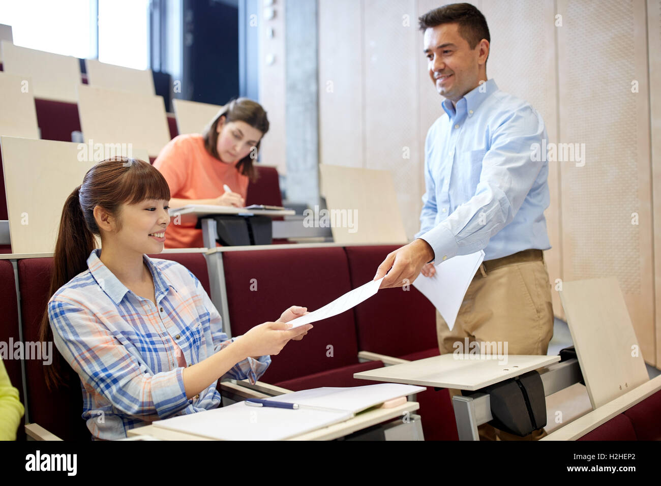 teacher giving tests to students at lecture Stock Photo - Alamy