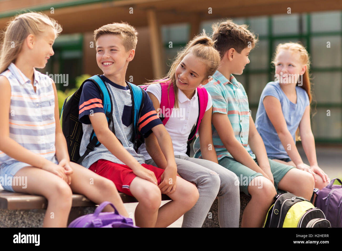 group of happy elementary school students talking Stock Photo - Alamy